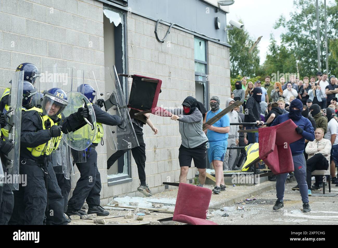 A chair is thrown at police officers as trouble flares during an anti ...