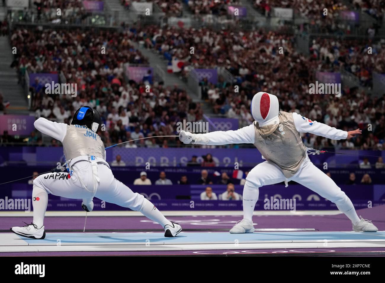Japan's Kazuki Iimura competes with France's Maxime Pauty in the men's ...