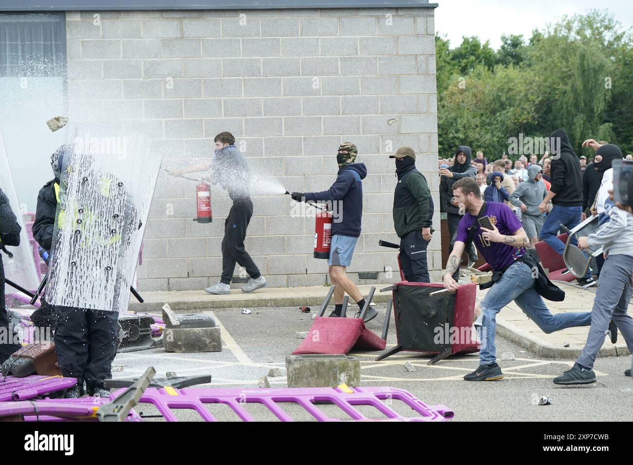 Fire extinguishers are used on police officers as trouble flares during ...