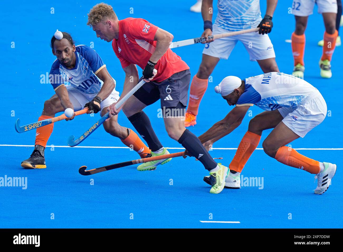 India's Hardik Singh, left, tries to block Britain's Jacob Draper ...