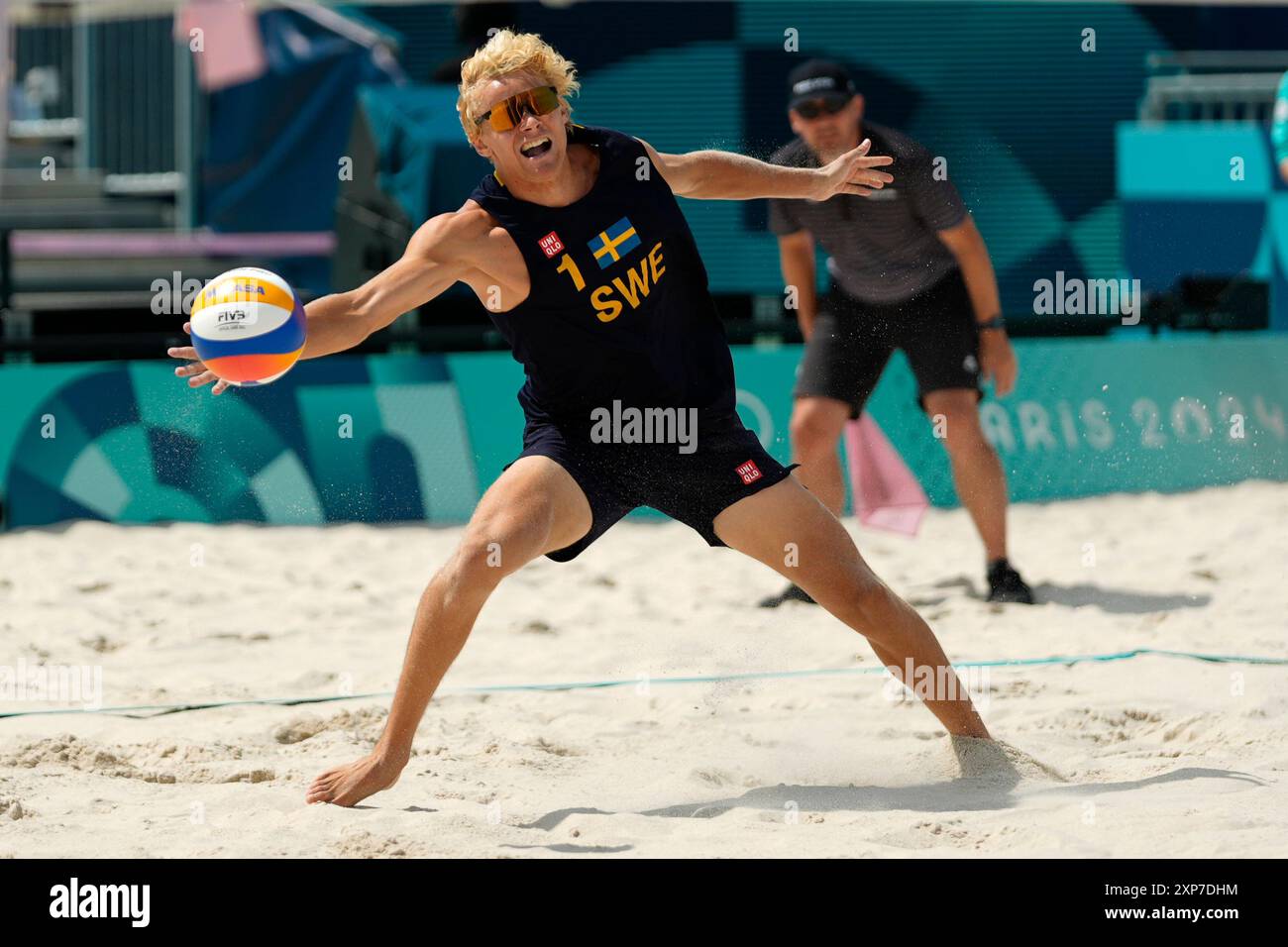 Sweden's David Ahmad reaches for a shot in a beach volleyball match ...