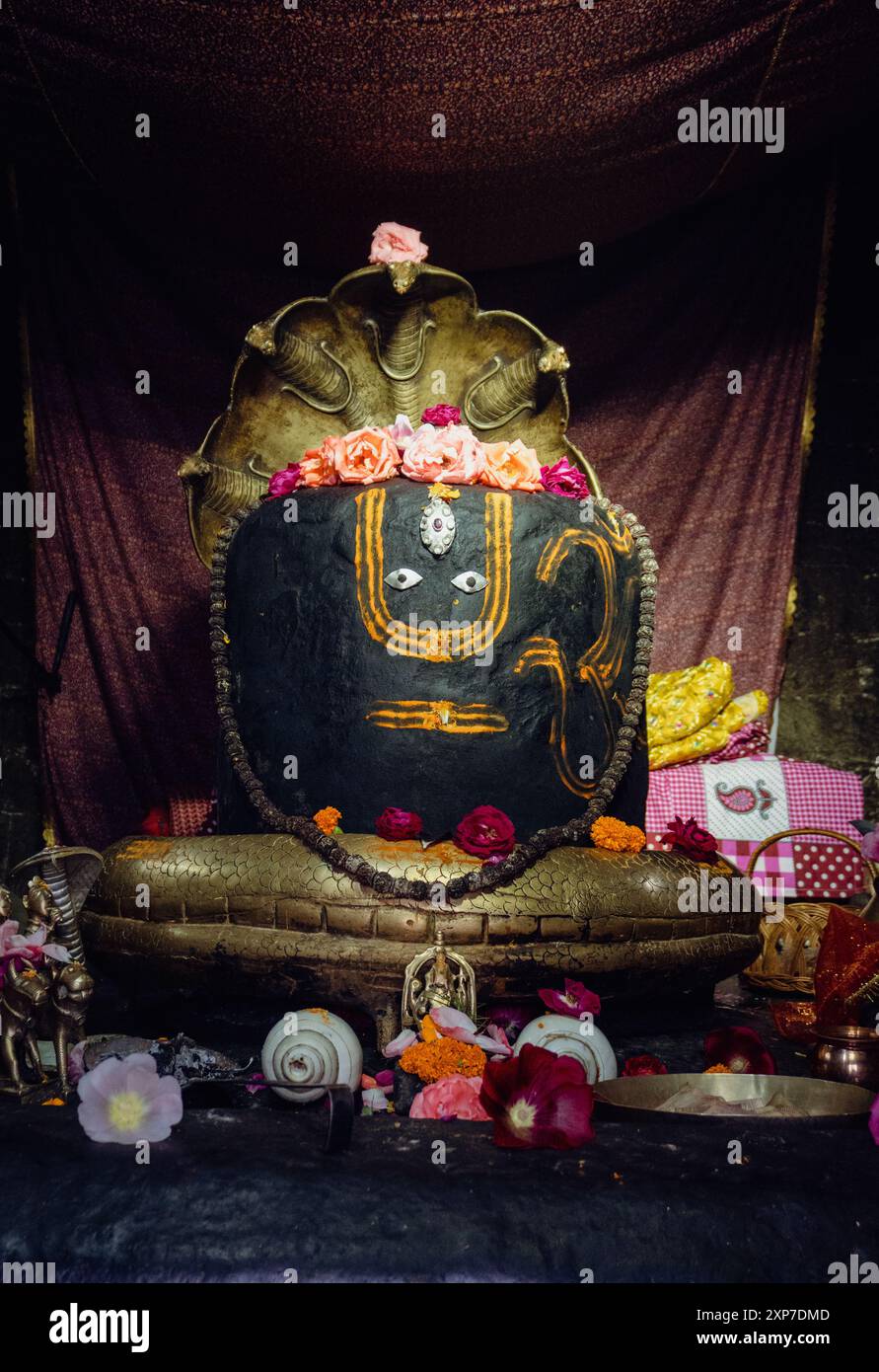 July25th2024, Himachal Pradesh, India. Black stone Shiva Lingam adorned ...