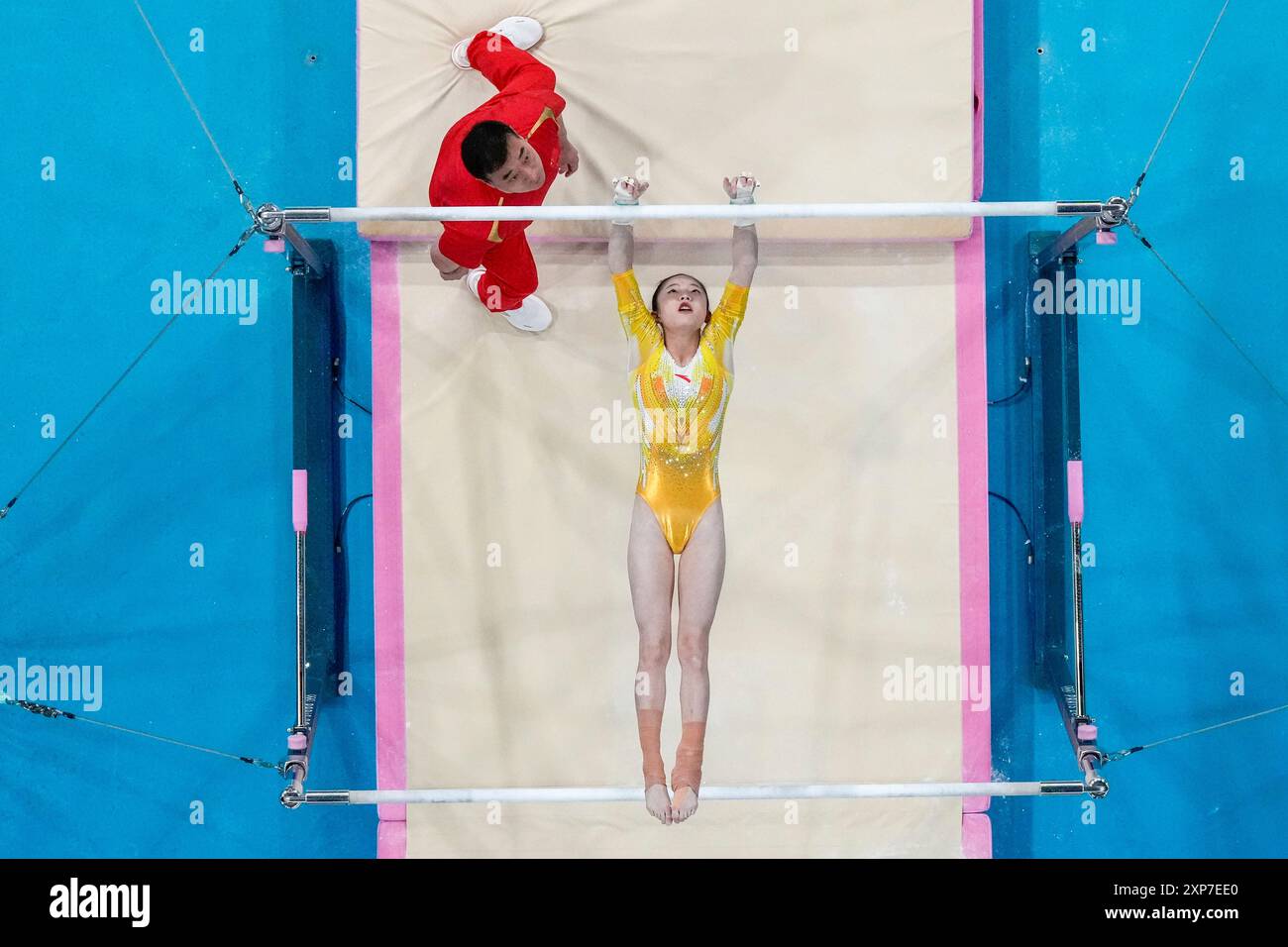Zhang Yihan, of China, performs on the uneven bars during the women's ...