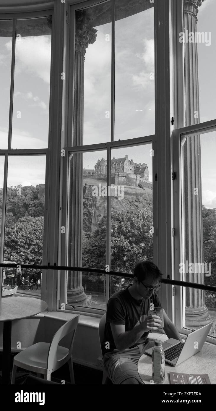 Remote worker in Waterstones coffee shop bay window with view of ...