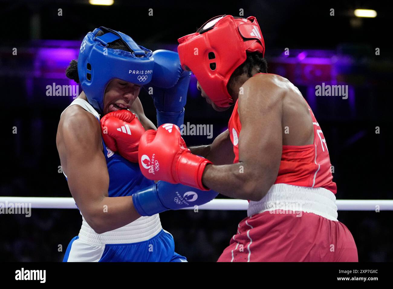 Refugee Olympic Team's Cindy Ngamba hits France's Davina Michel in ...