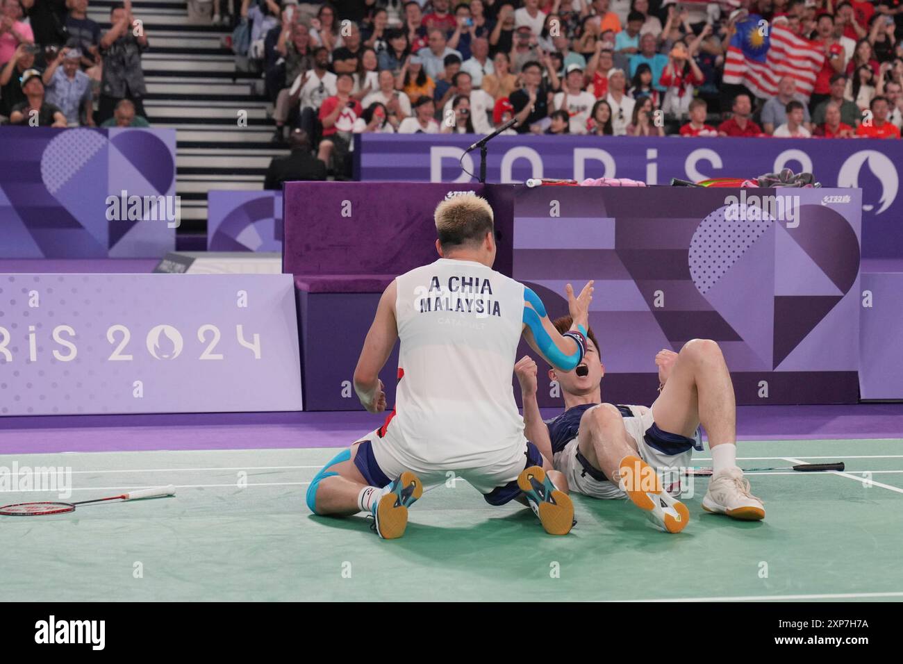 Malaysia's Aaron Chia, left, and Soh Wooi Yik celebrate after defeating Denmark's Kim Astrup and ...