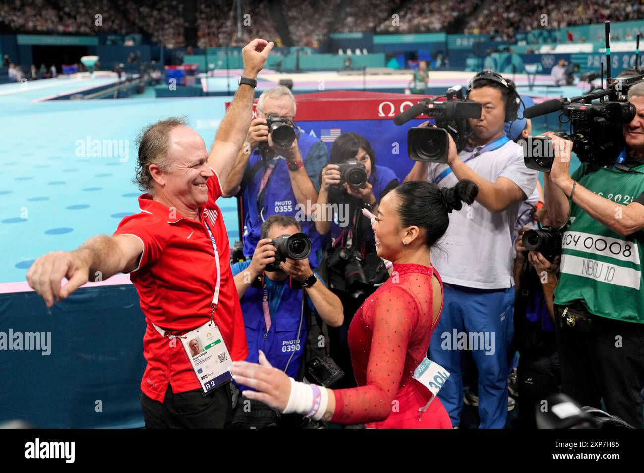 Suni Lee, of the United States, celebrates with coach Jess Graba, left ...
