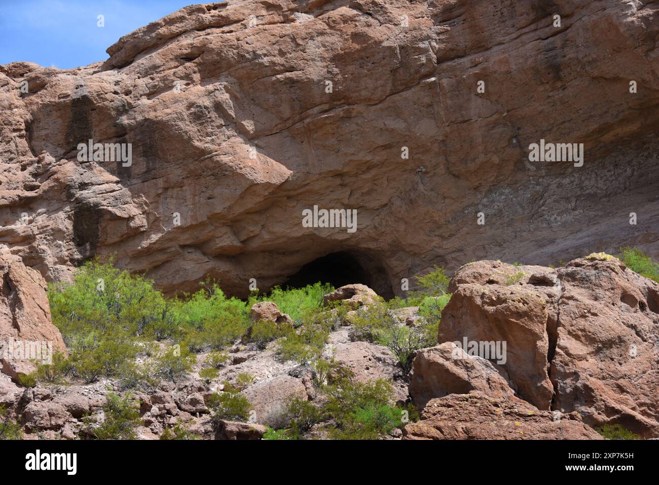 Small cave enters a red, sandstone cliff at San Lorenzo Canyon in New ...