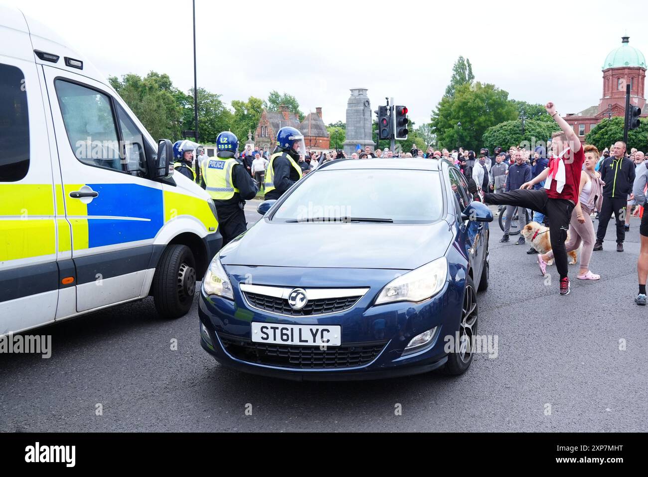 A man kicks a car during an anti-immigration protest in Middlesbrough ...