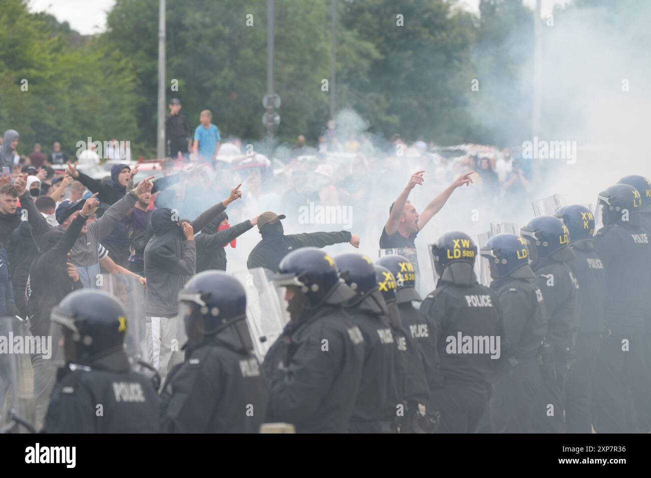 Police officers face protesters during an anti-immigration ...