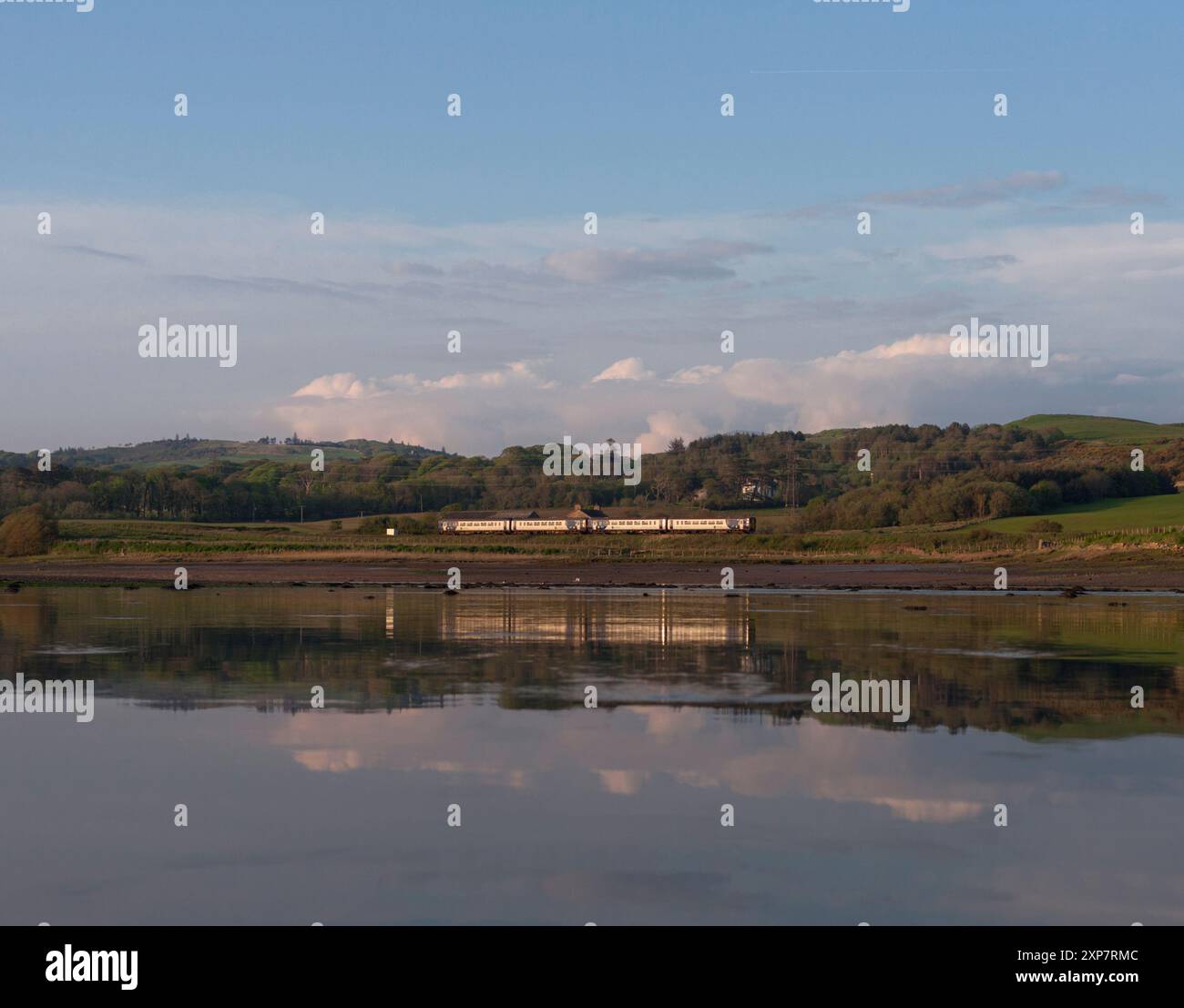 2 Northern Rail class 156 diesel trains passing Ravenglass, reflected ...