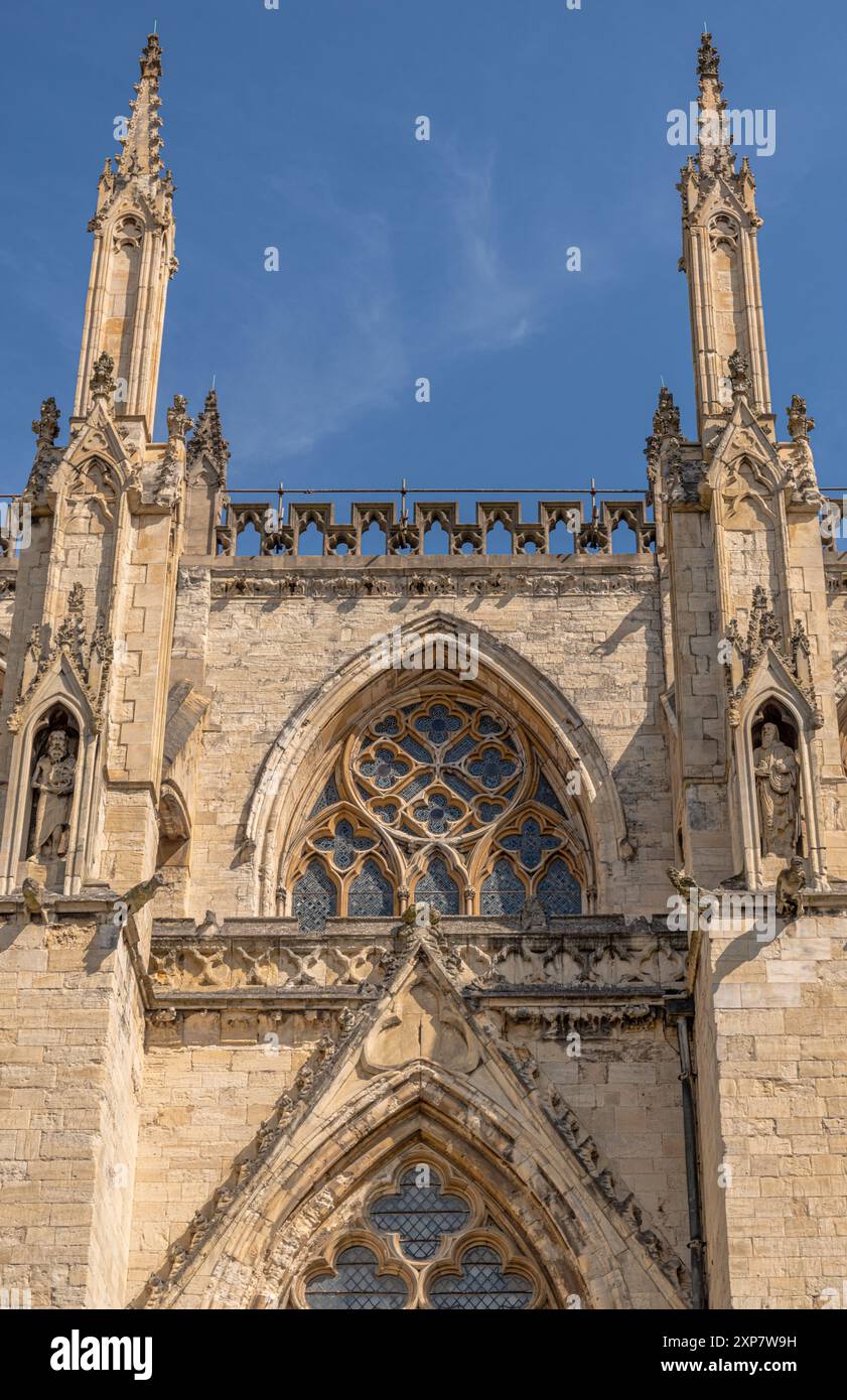 A section of a medieval cathedral tower with a stained glass windows ...