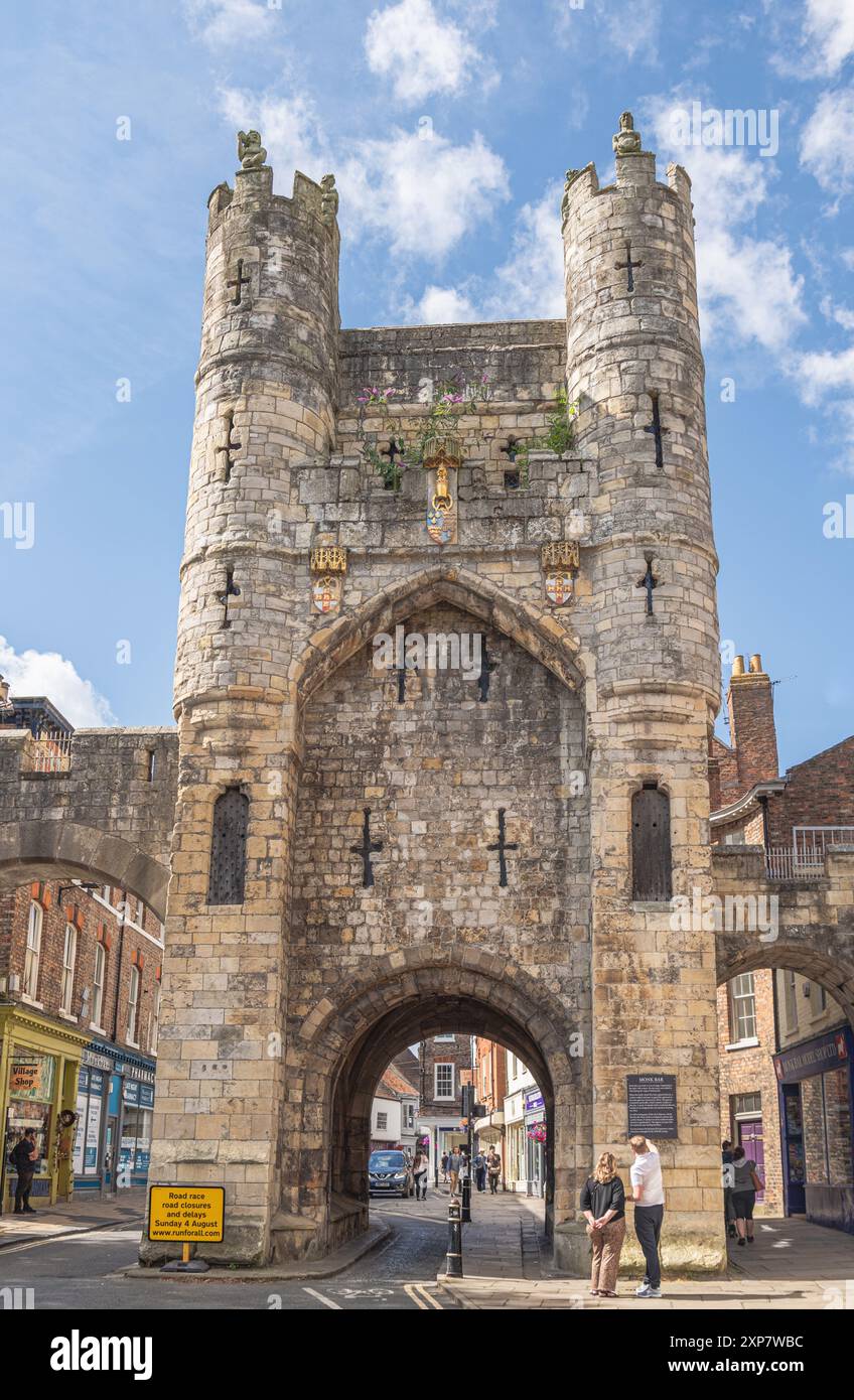 Historic city gateway with an arch and a city wall in the sunshine ...