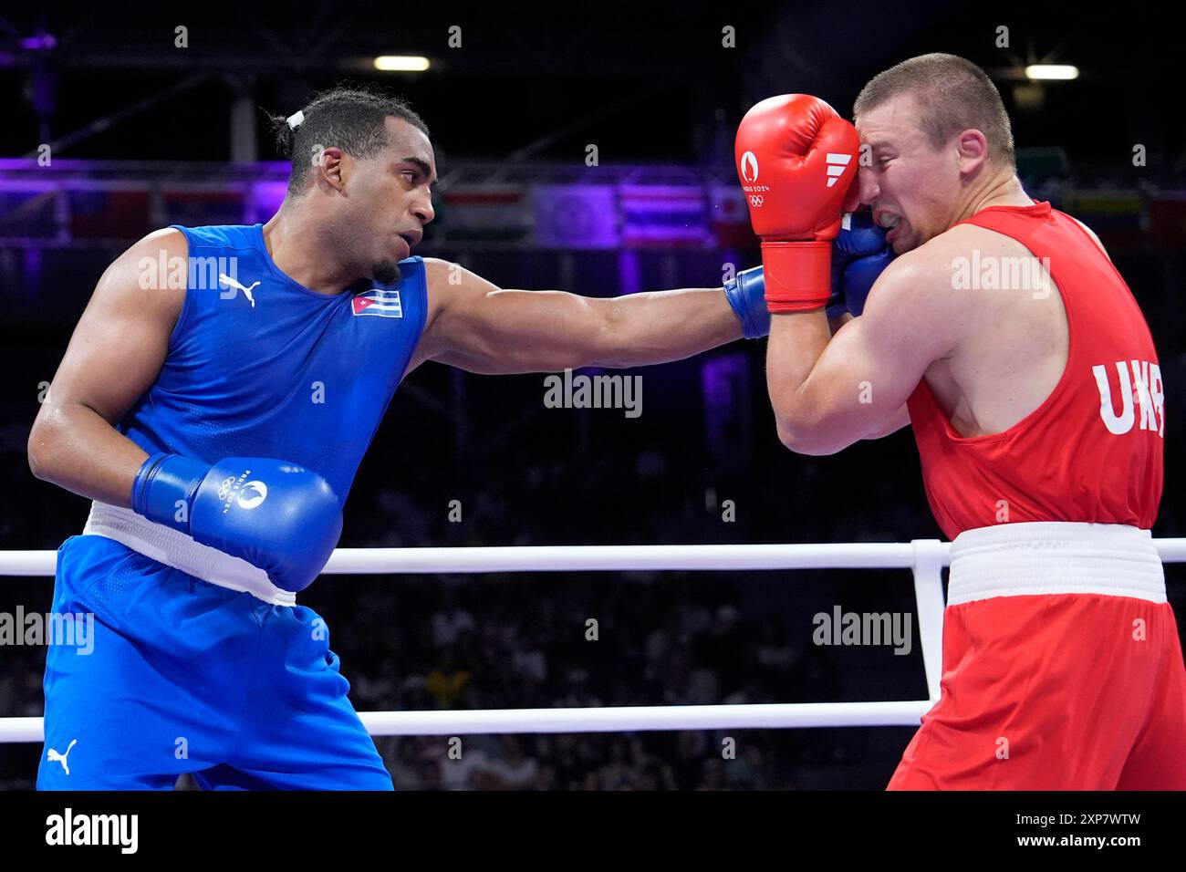 Cuba's Arlen Lopez hits Ukraine's Oleksandr Khyzhniak in their men's 80 ...
