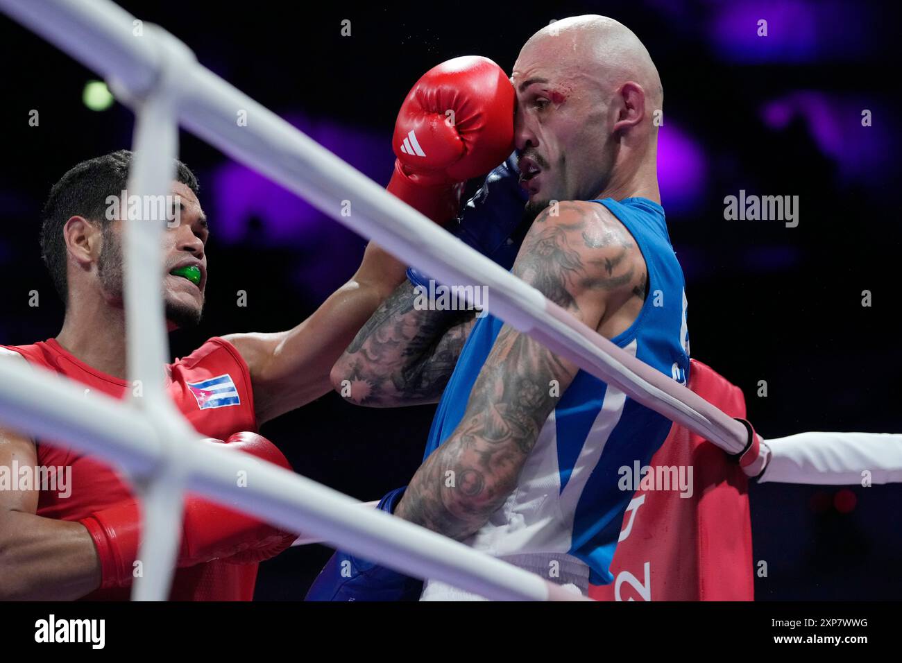 Cuba's Erislandy Alvarez hits Georgia's Lasha Guruli in their men's 63.5 kg semifinal boxing ...