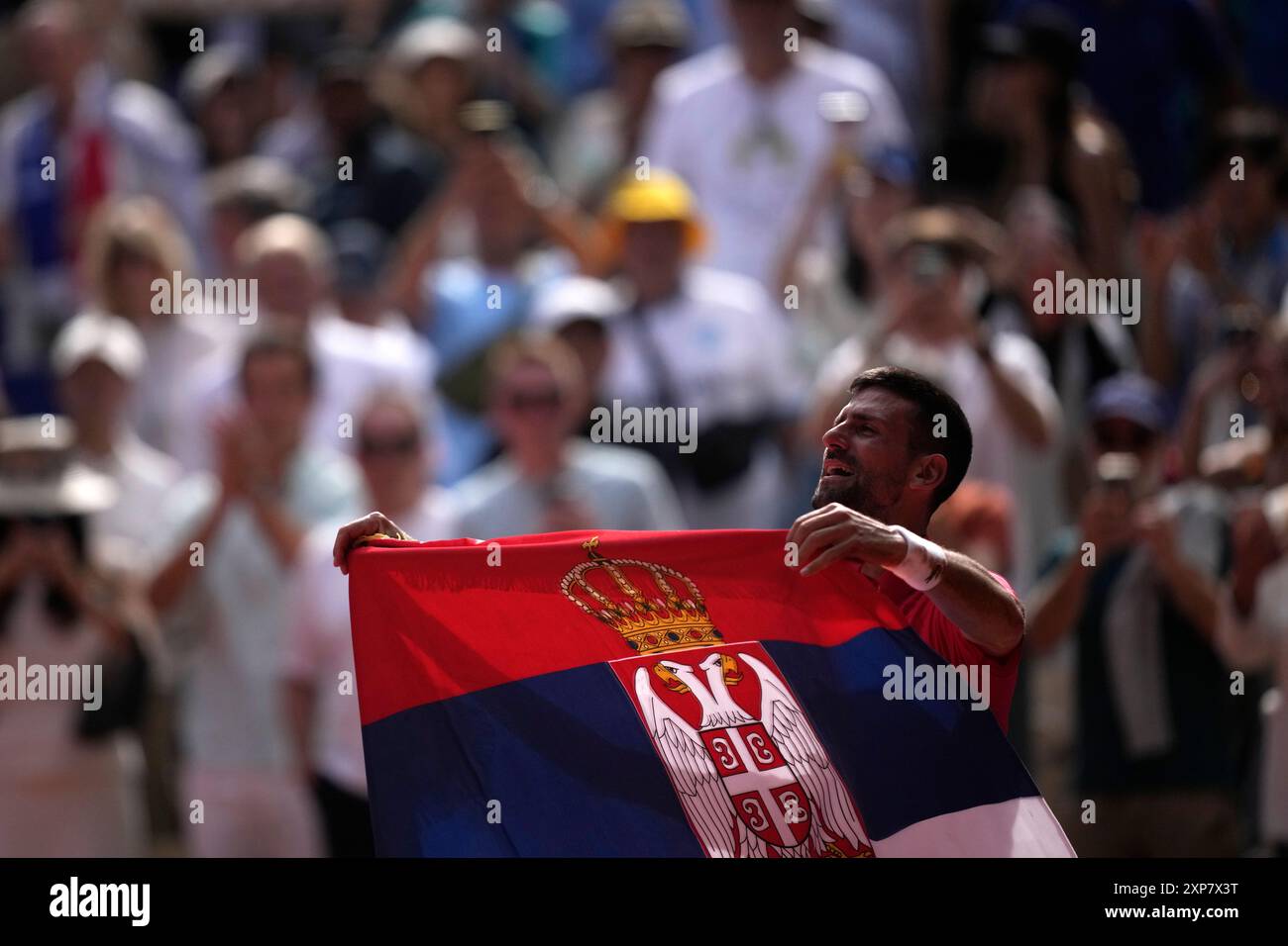 Serbia's Novak Djokovic holds his national flag after defeating Spain's ...