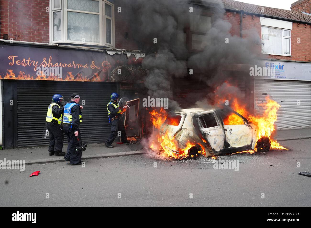 A car burns on Parliament Road, in Middlesbrough, during an anti ...