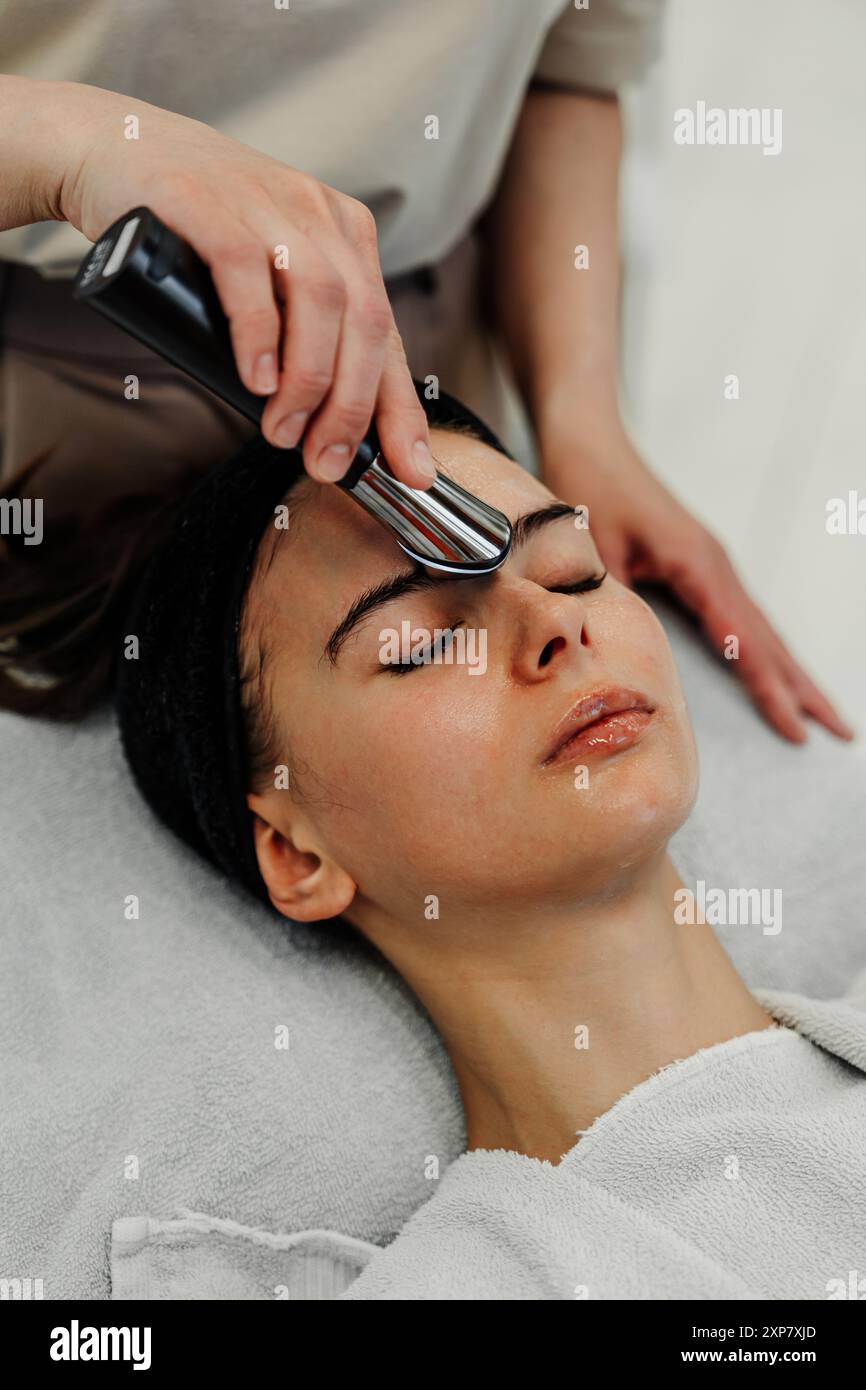 Facial Treatment in Progress at a Spa With a Client Relaxing on a ...