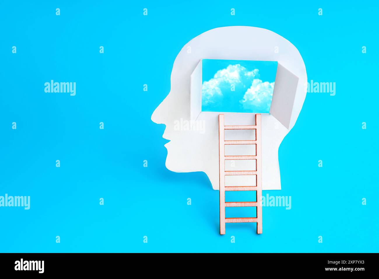 Paper-crafted head shape with a wooden ladder leading to an open window ...