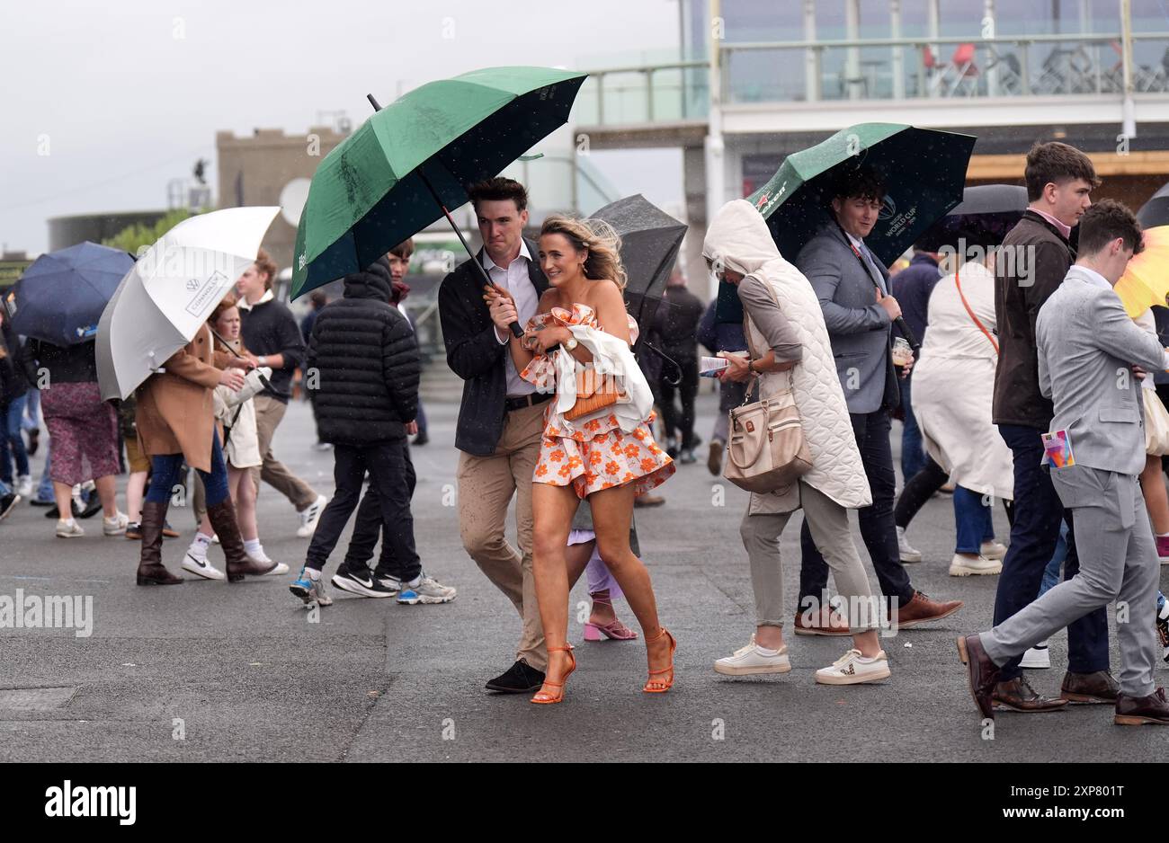 Racegoers shelter from the rain on day seven of The Galway Races Summer ...