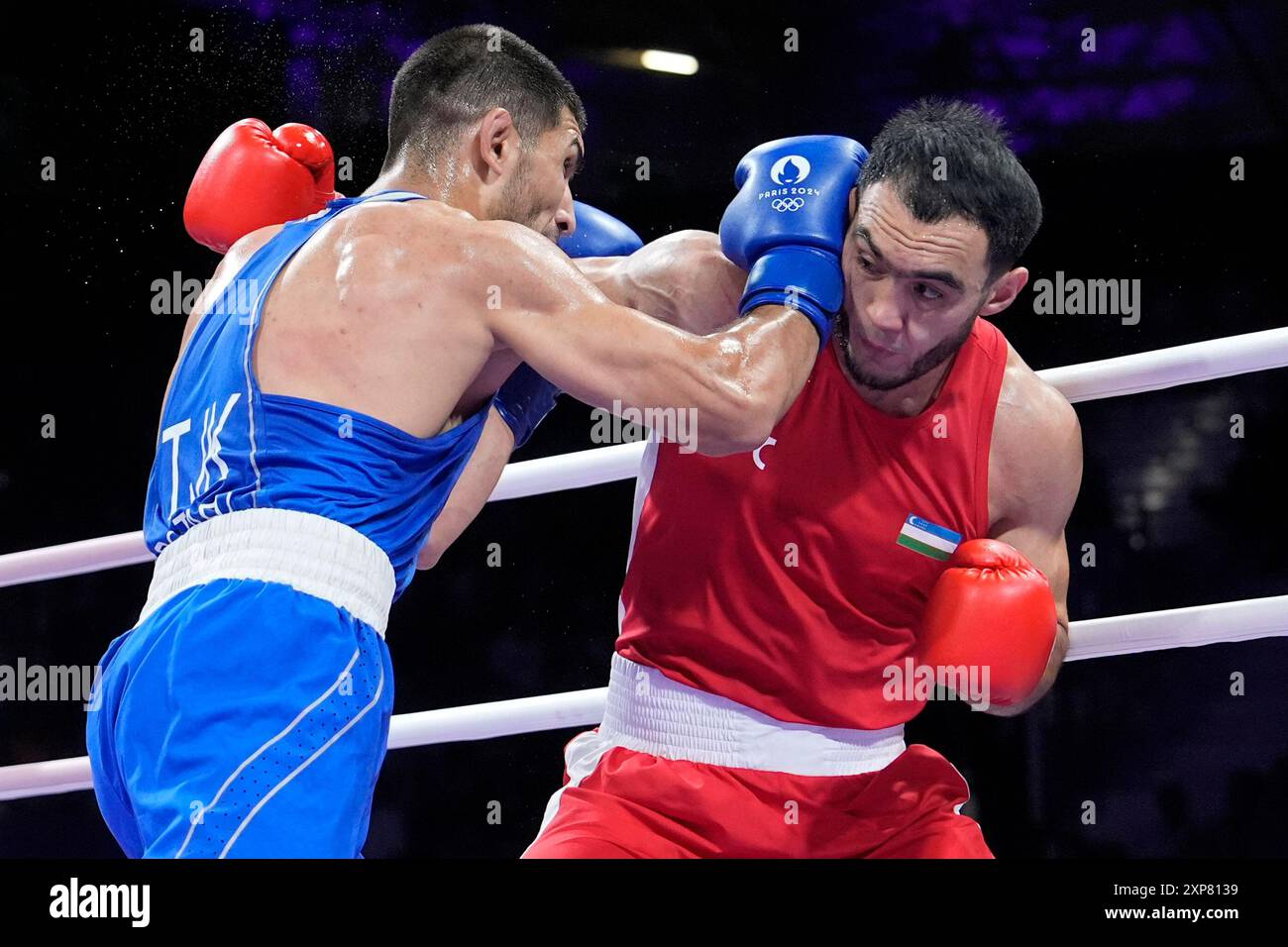 Uzbekistan's Lazizbek Mullojonov, right, fights Tajikistan's Davlat Boltaev in their men's 92 kg ...