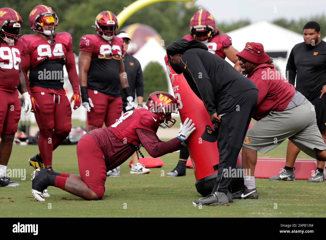 Washington Commanders defensive tackle Phidarian Mathis, center, takes ...