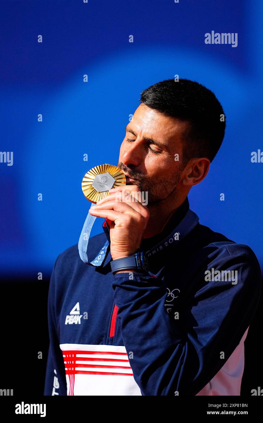 Gold medallist Novak Djokovic of Serbia poses on the podium during the ...