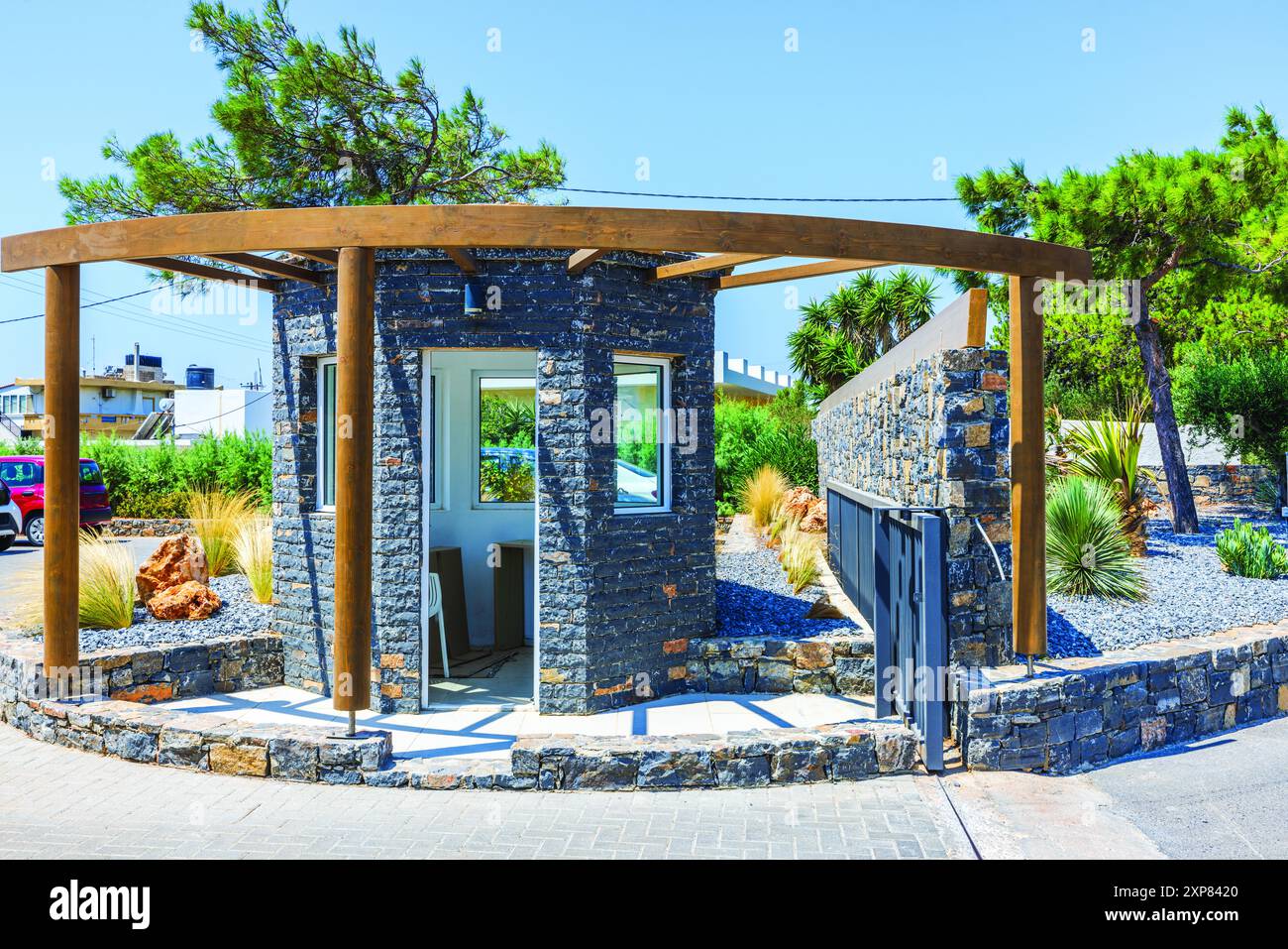 Security guard booth at hotel entrance surrounded by landscaped gardens ...