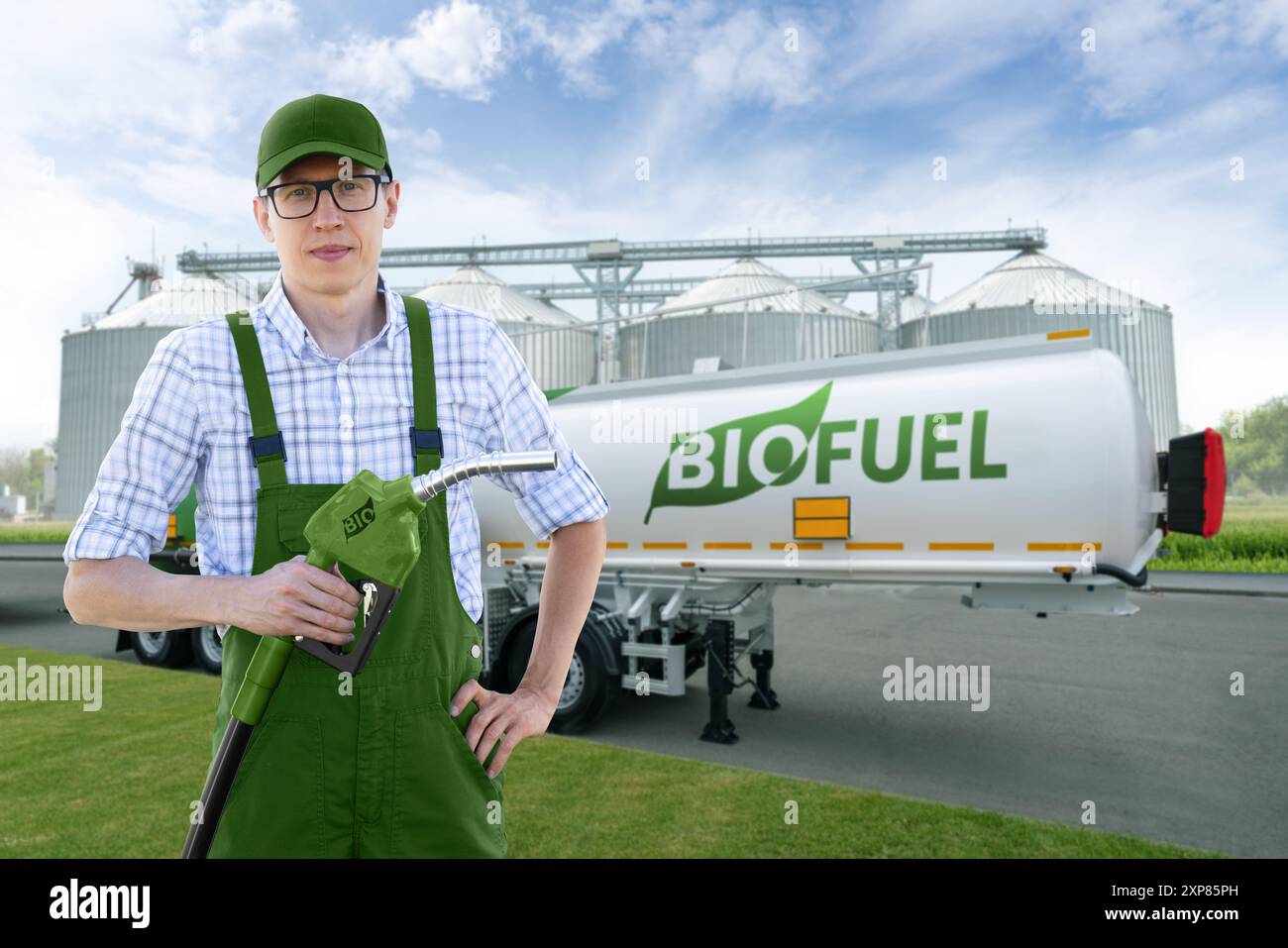 Man with fuel nozzle with inscription BIO on a background of tank ...