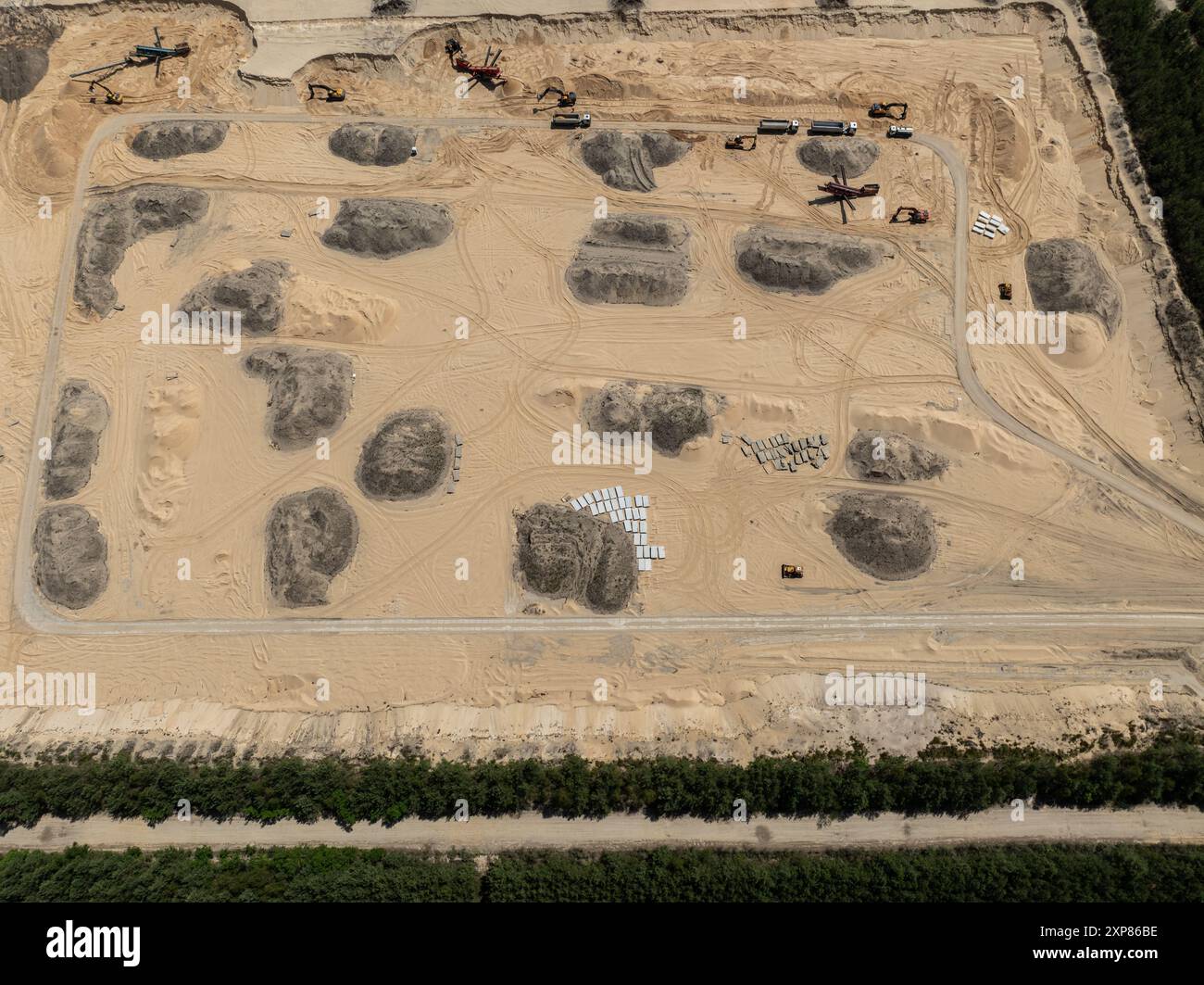 Quarrying sand. Machines and truck working on sand mine. Mining quarry ...