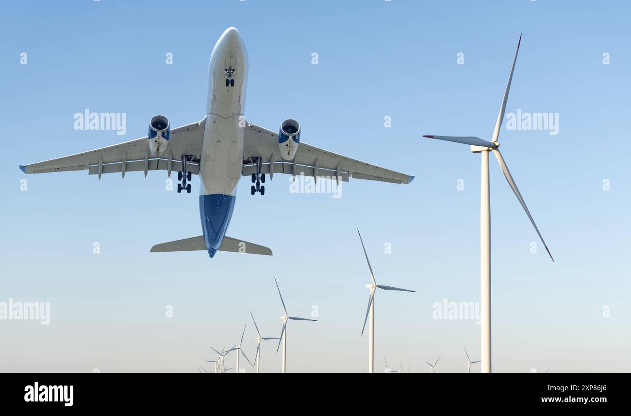 Wind turbines and plane in the blue sky Stock Photo - Alamy