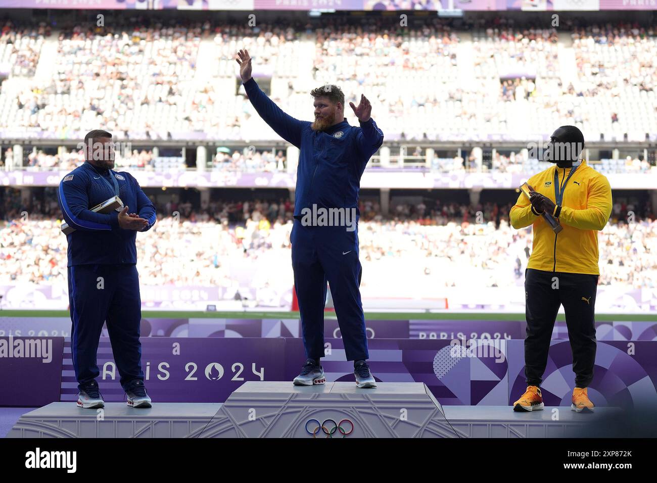 Paris, France. 4th Aug, 2024. Gold medalist Ryan Crouser (C) and silver medalist Joe Kovacs (L ...