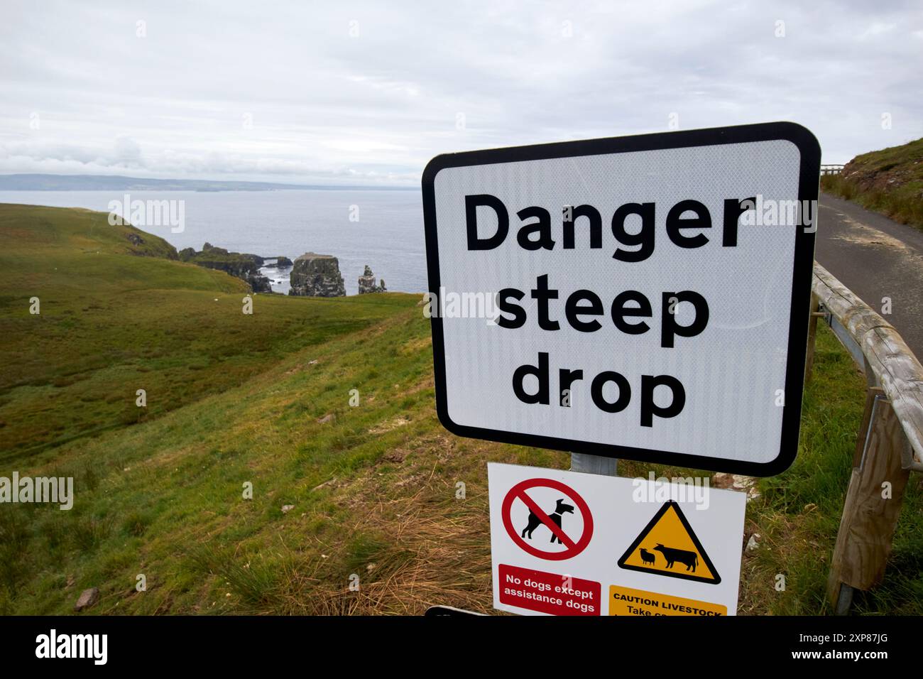 danger steep drop sign on single track road in remote area of rathlin ...