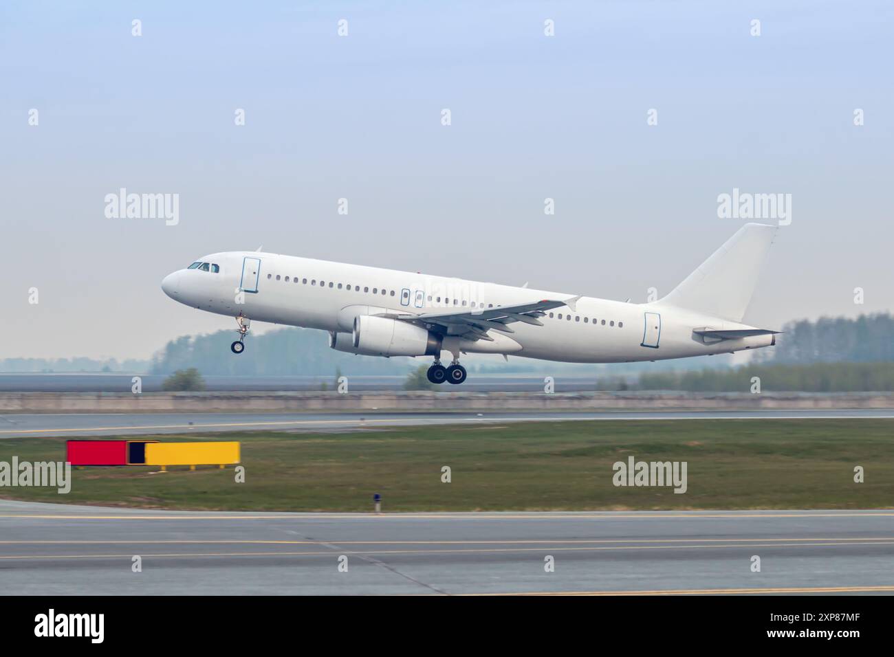 Modern white passenger jetliner takes off runway Stock Photo - Alamy