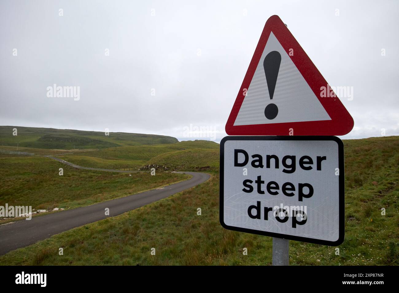 danger steep drop sign on single track road in remote area of rathlin ...