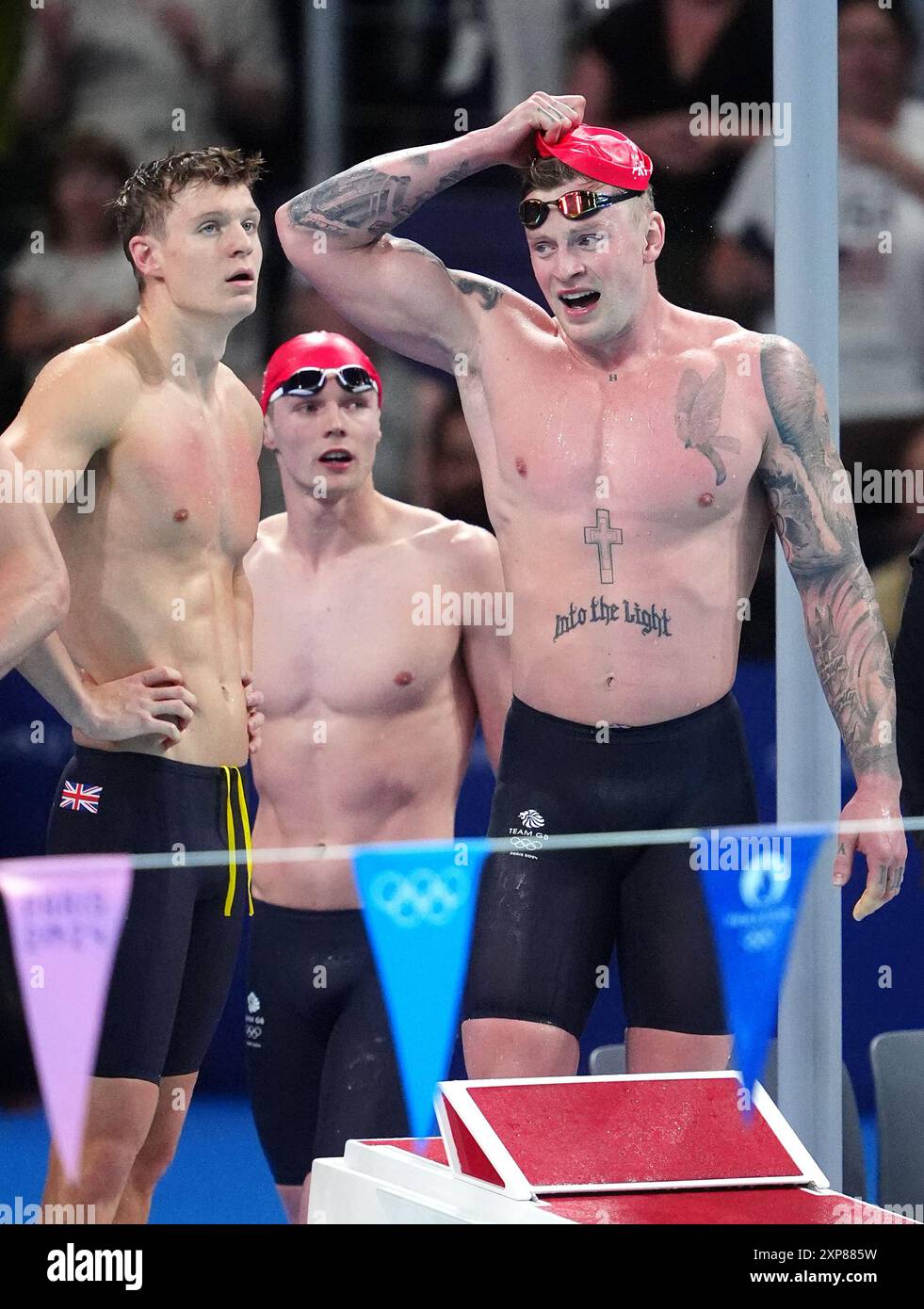 Great Britain's Adam Peaty (right) and team-mates react following ...
