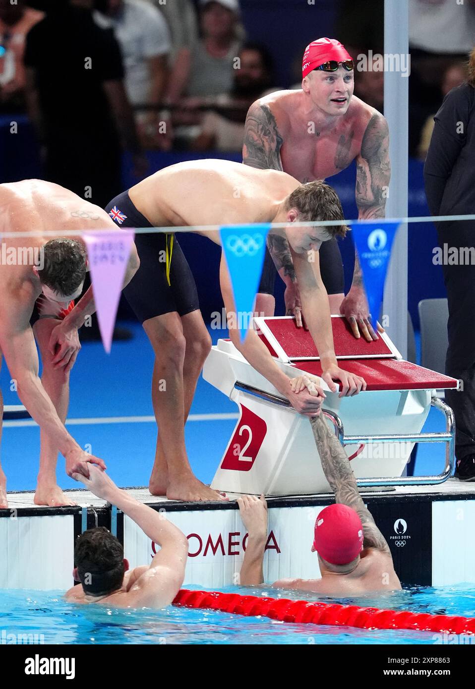 Great Britain's Adam Peaty (right) and team-mates react following ...