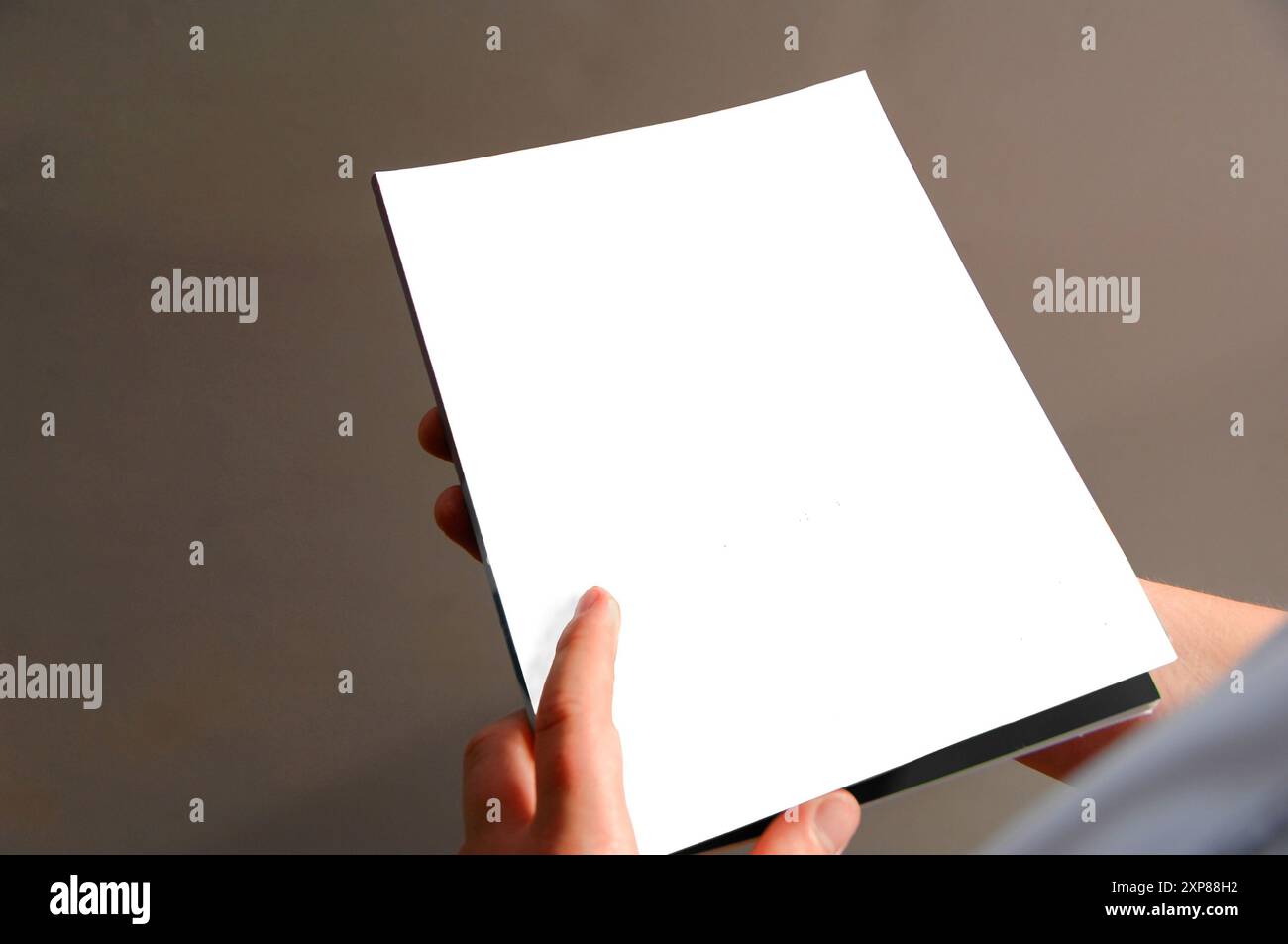 child's hands from behind holding a white paper Stock Photo - Alamy