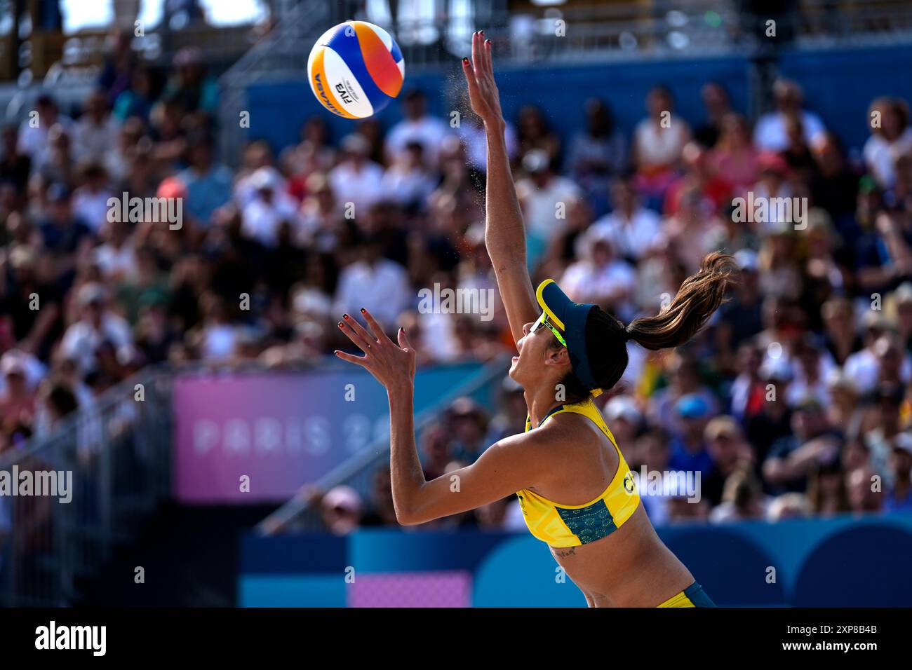 Australia's Taliqua Clancy serves in a beach volleyball match against ...