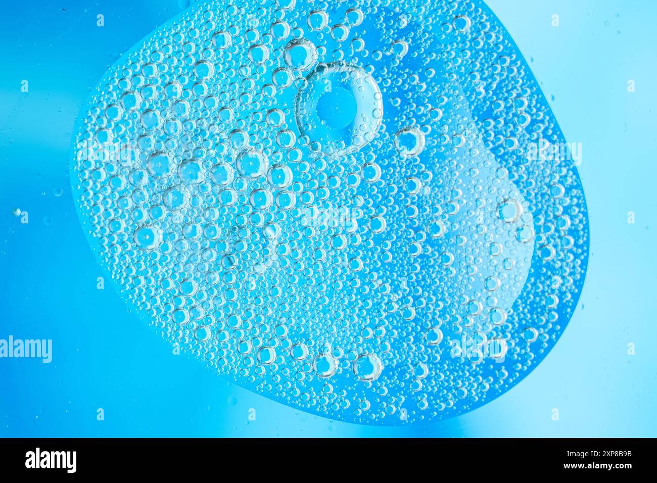 Abstract image featuring a blue, organic-shaped liquid form with ...