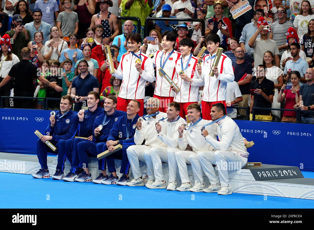 The team of China, USA and France pose with their medals following the ...