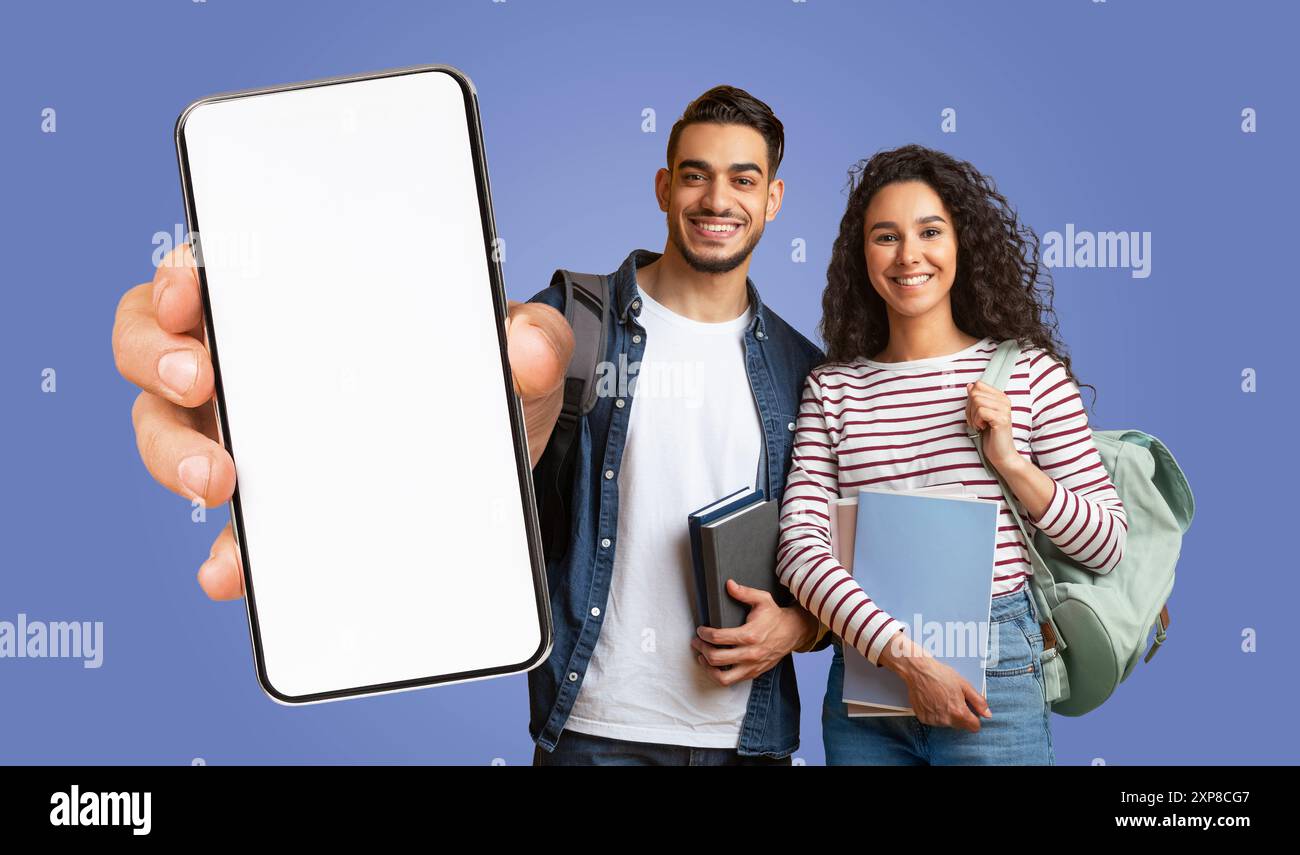Happy Students Holding Books and Smartphone With Blank Screen Stock ...