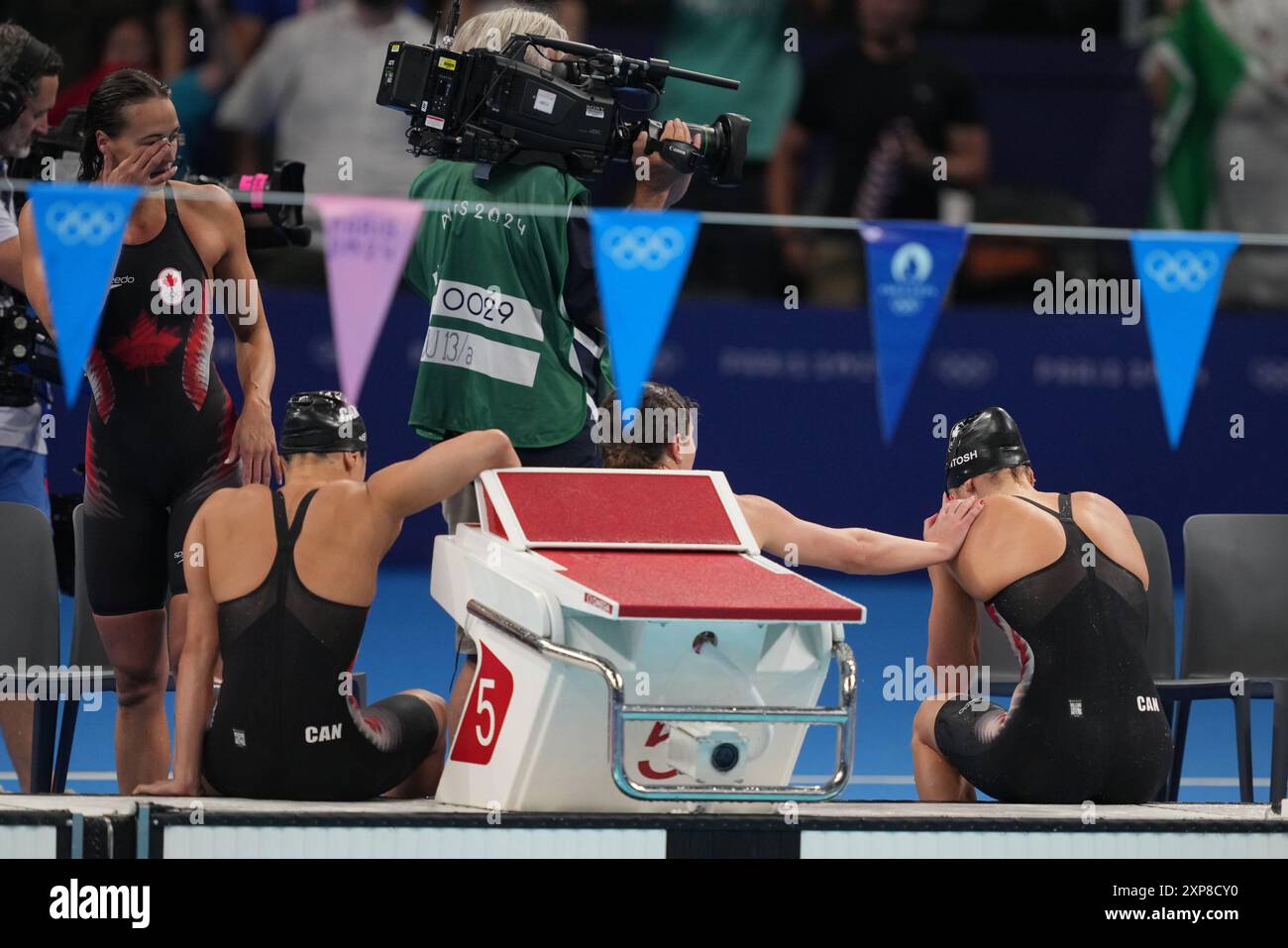 Canada's Summer McIntosh (right) is consoled by teammates following the ...