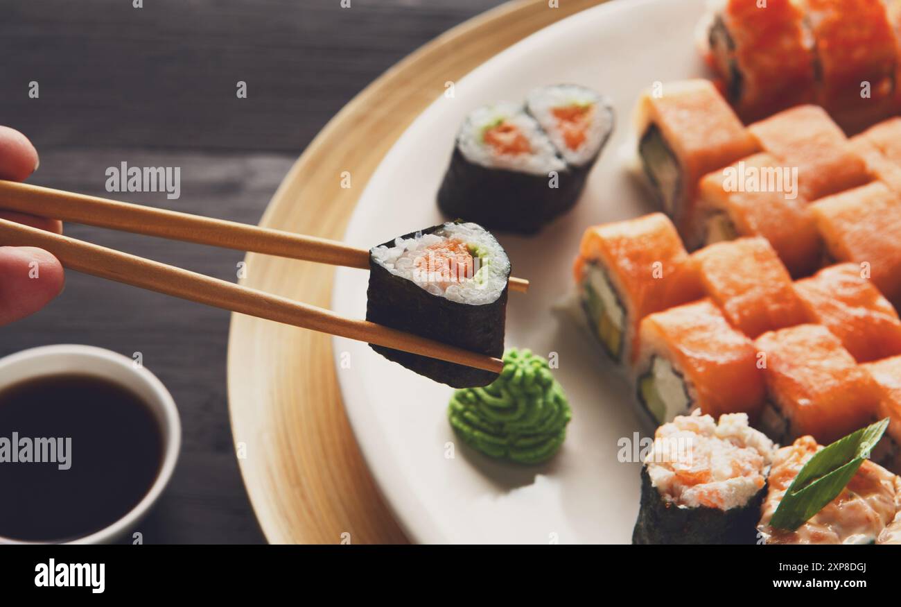 Eating sushi rolls at japanese food restaurant Stock Photo - Alamy
