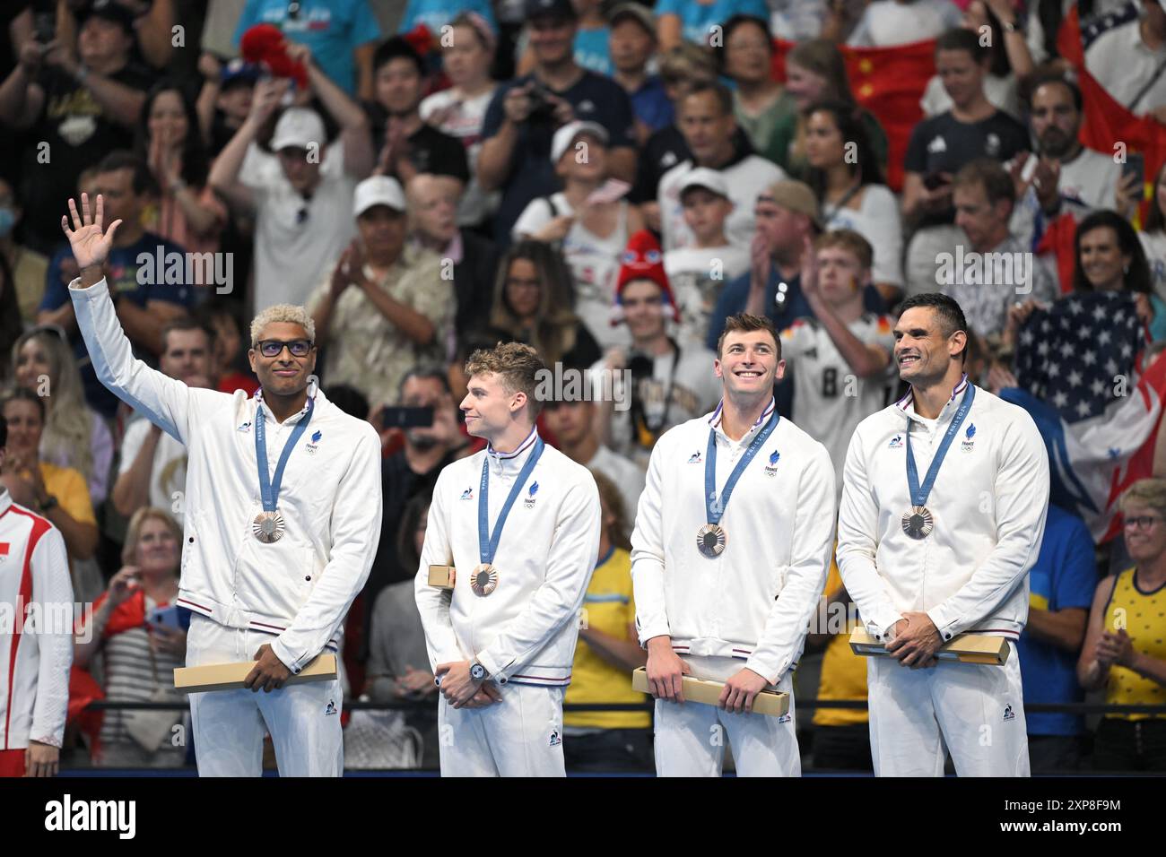 Nanterre, France. 04th Aug, 2024. (L to R) Bronze Medalists Yohann Ndoye-Brouard, Leon Marchand ...