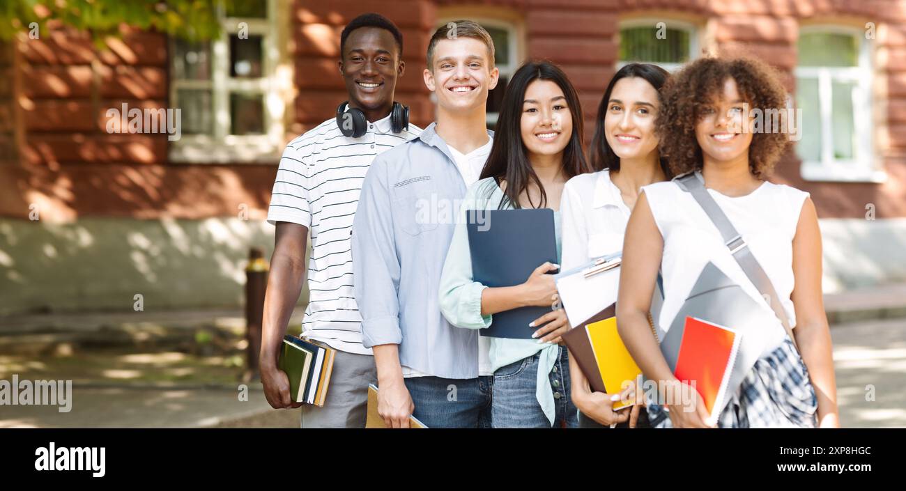 Group of smiling multicultural students posing near university campus ...