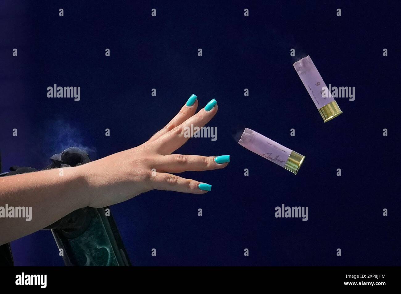 Britain's Amber Jo Rutter ejects empty cartridges from her gun as she ...