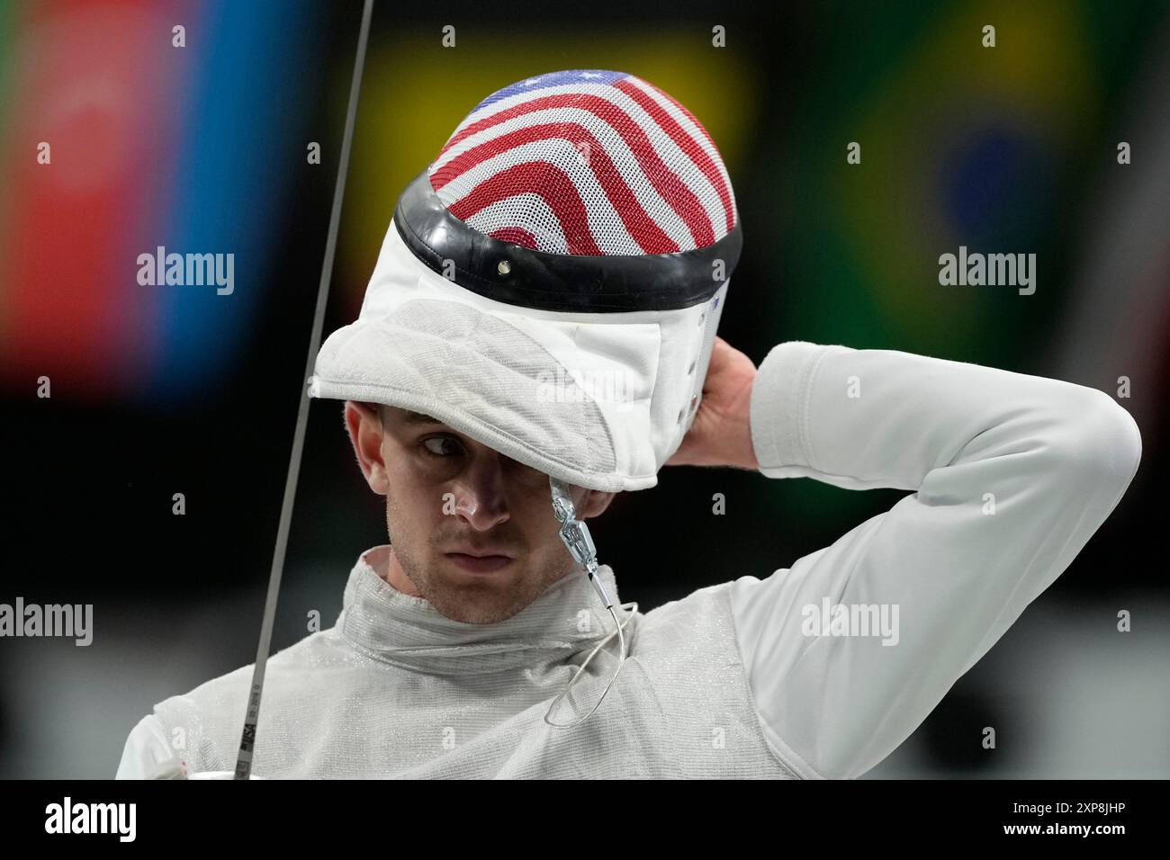 United State's Nick Itkin wears his mask as he competes with Italy's ...