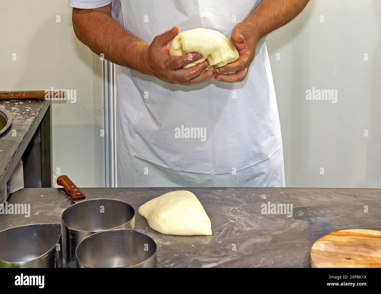 Male employee preparing steamed cheese outside on a market Stock Photo ...
