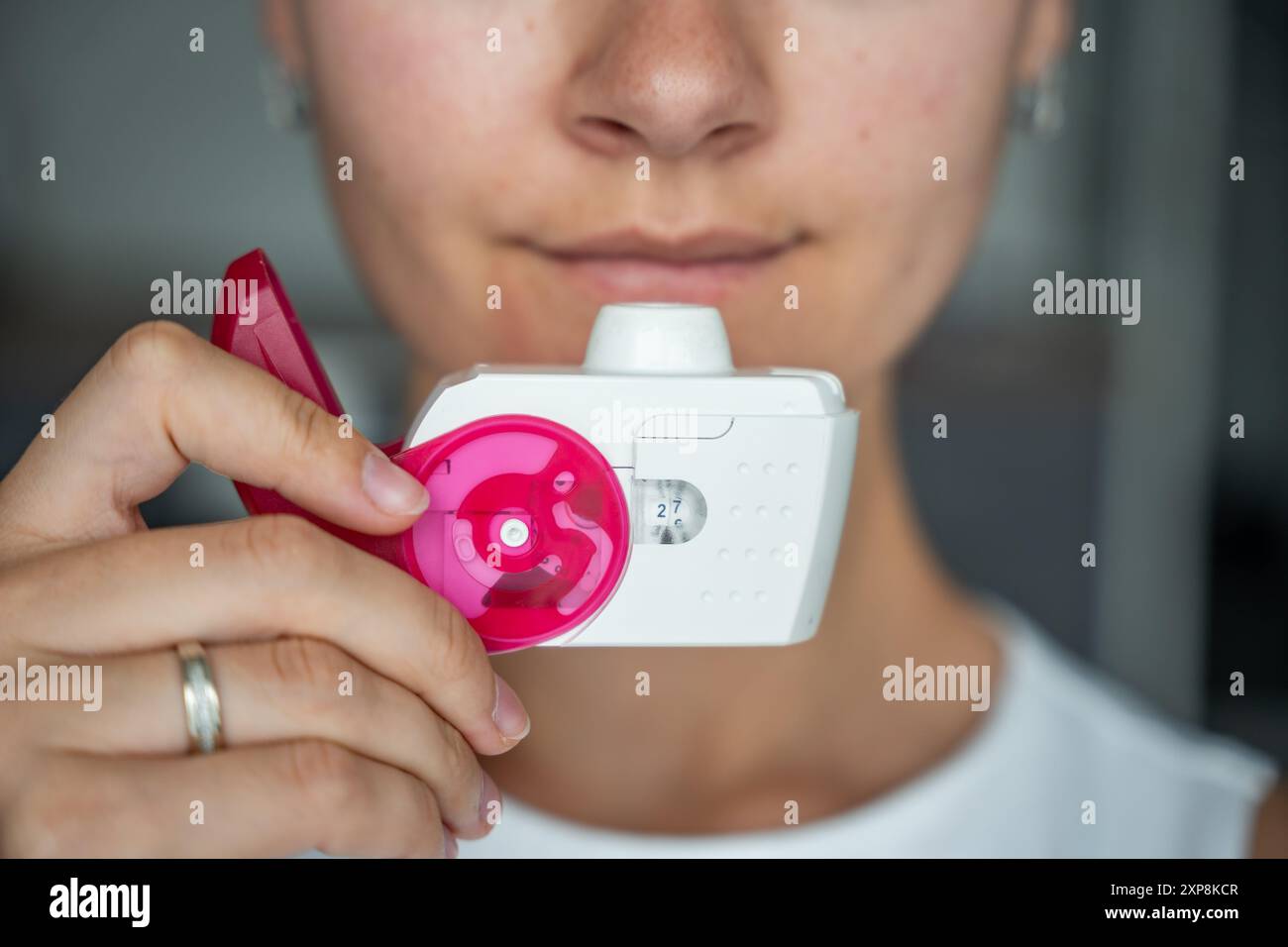 Close up view of woman using medicine dry powder inhaler for treatment ...